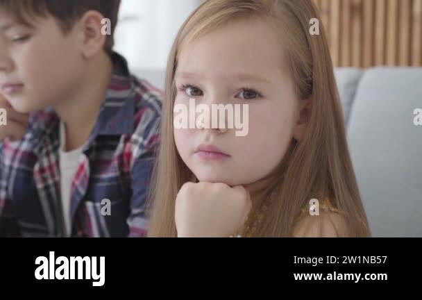 Close-up portrait of sad Caucasian girl with brown eyes looking at ...