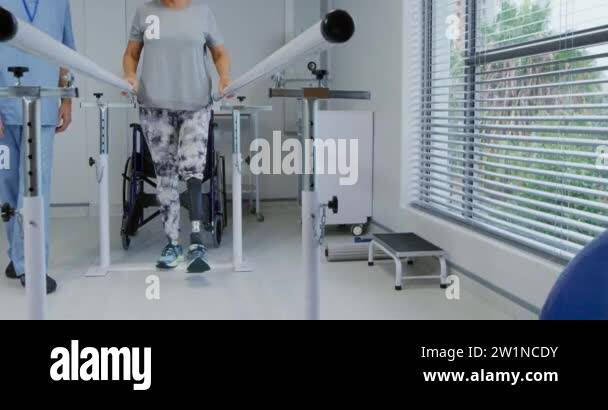 Front view of a Caucasian male physiotherapist helping a Caucasian ...