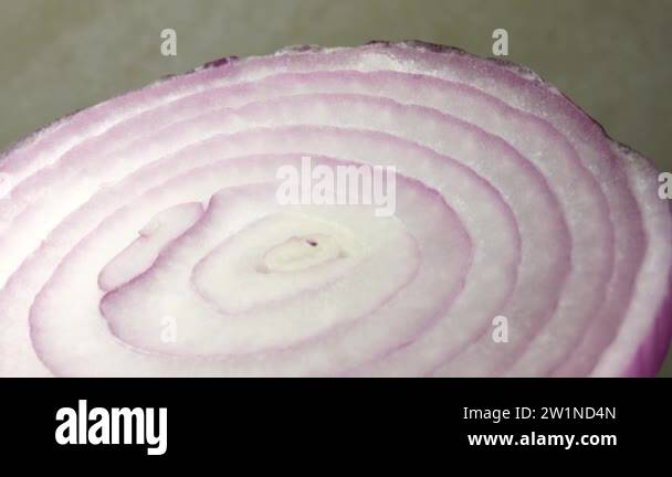 Sliced red onion rings rotating in 4K. Closeup top view of healthy food ...