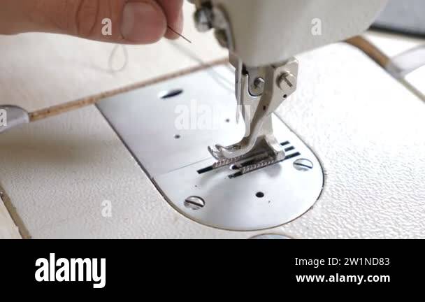 Small clothes and bag manufacture. Process of inserting thread into ...
