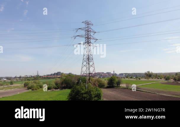 Power pylons and high voltage lines in an agricultural landscape. High ...