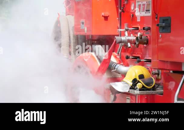 Firefighter fighting with fire flame protection property. Fireman wear ...