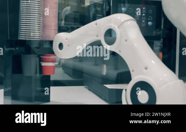 Arm of a robot is relocating and filling a coffee cup. Futuristic robot, innovative technology ...
