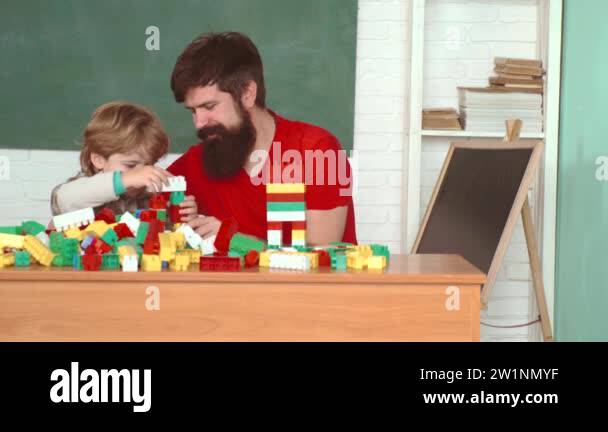 Son helping her father build the wall. Father and son - Childhood ...