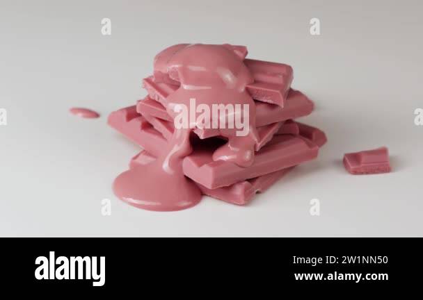 Melted ruby chocolate pouring into a piece of chocolate bars Stock ...