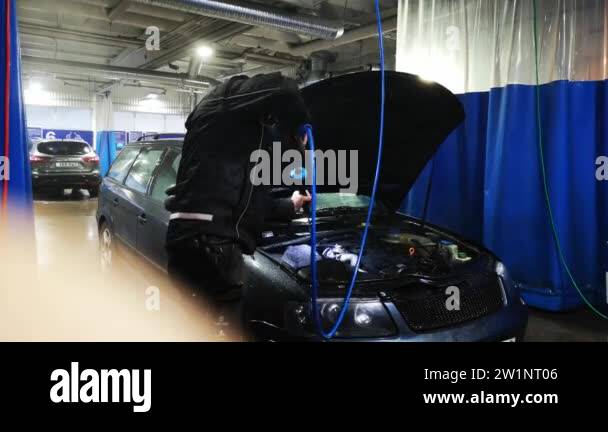 Self service car wash. Man washing his car at automobile washing ...