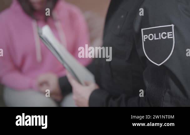 Male Caucasian police officer holding crime victims hands, brunette ...