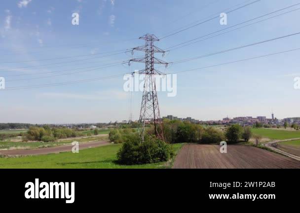 Power pylons and high voltage lines in an agricultural landscape. High ...