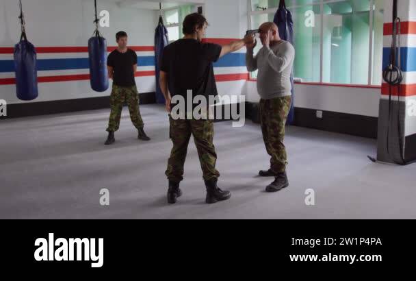 Krav Maga Training. Front view of a bald Caucasian male instructor ...