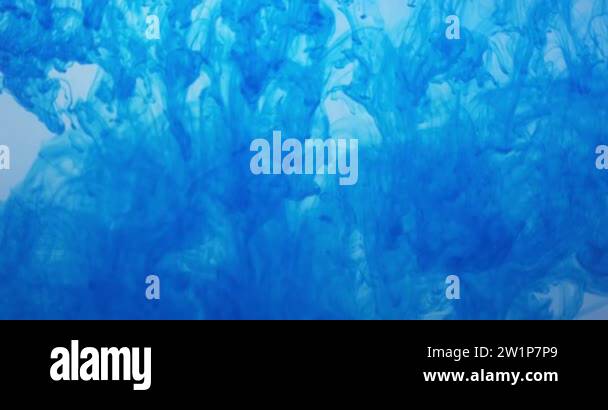 Blue color paint ink drops in water at white background. Inky cloud ...