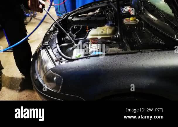 Self service car wash. Man washing his car at automobile washing ...