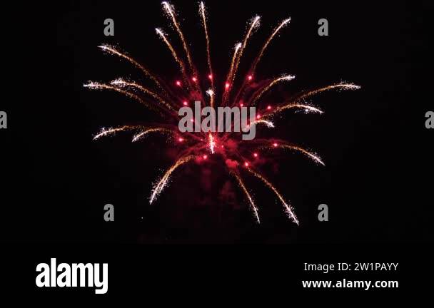 shining fireworks with bokeh lights in the night sky. glowing fireworks ...