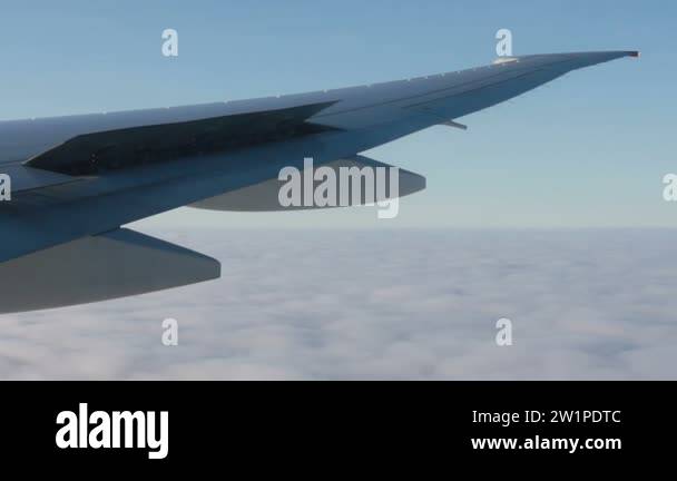 Airplane flight. Wing of an airplane flying above the clouds with ...