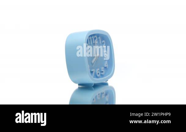 Blue alarm clock showing eight oclock spinning rotating 360 isolated on ...