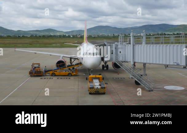 Airplane boarding and loading cargo containers. DALAT, VIETNAM ...
