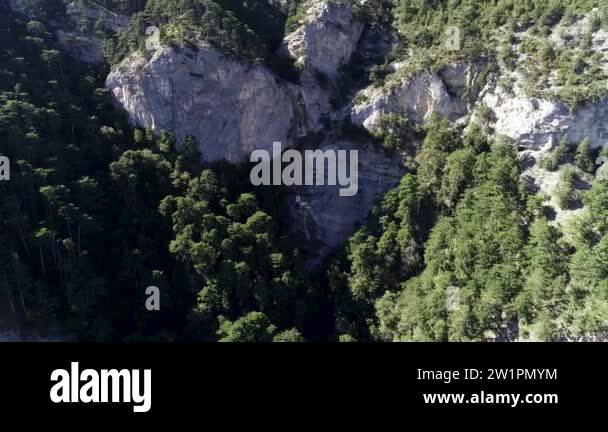 Aerial view of the forest and cliff at slope of the mountain. Shot ...
