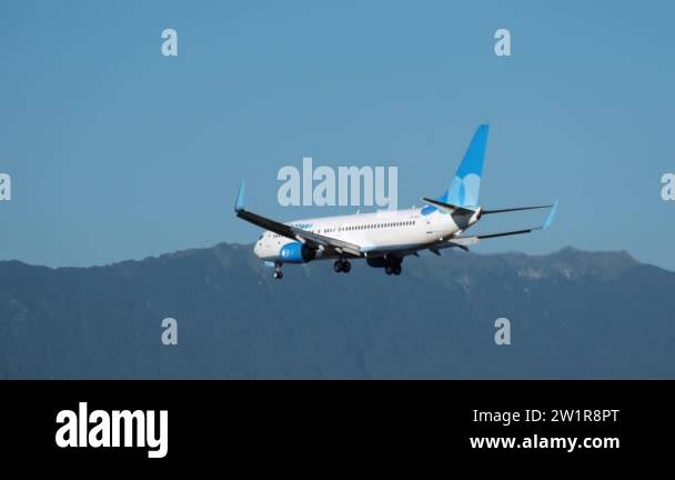 Jet airplane descending before landing in airport. The plane overhead ...
