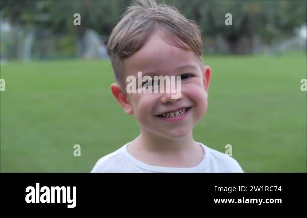 Portrait Funny little boy smiling chil looking at camera are walking on ...