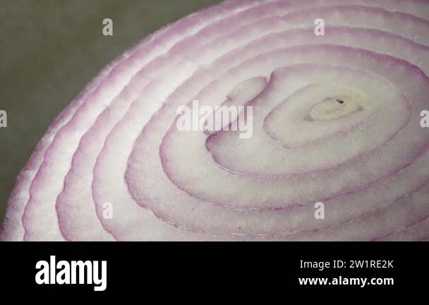 Sliced red onion rings rotating in 4K. Closeup top view of healthy food ...