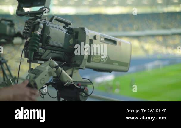Cameraman with a camera in the stadium during a football match. TV ...