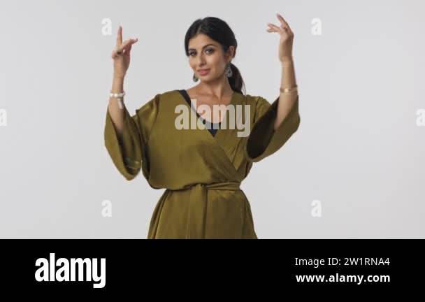 Pleased pretty hindu woman in traditional dress dancing and enjoying ...