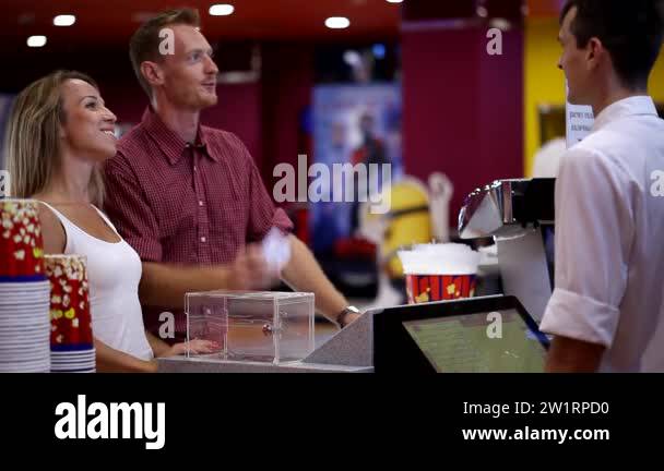 Young attractive happy excited guy girl couple making popcorn order ...
