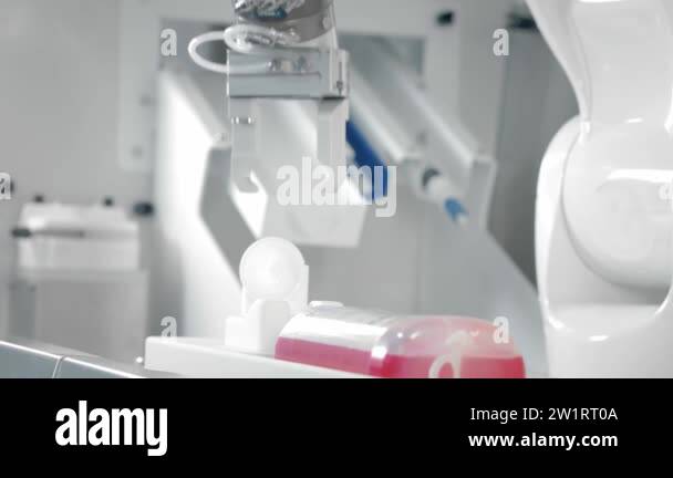 Robotic arm makes an injection with chemotherapy medicine. Two ...