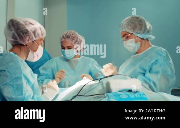 Facial plastic surgery. Teamwork with nurse and surgeon performing ...