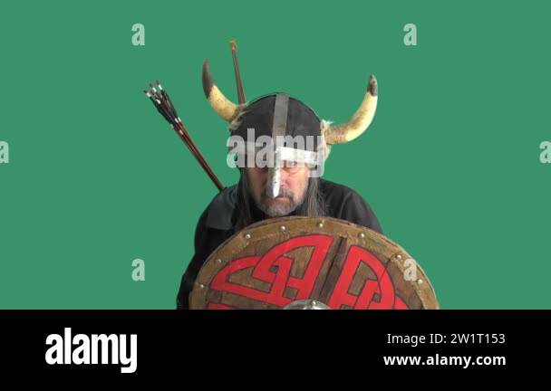 Portrait of an aggressive angry elderly viking wearing a helmet with ...