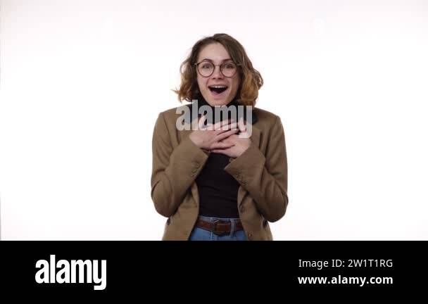 Over excited female with curly hairstyle, laughs happily, expresses ...