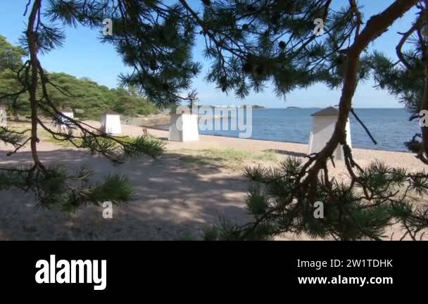 Old-fashioned changing clothes cabins on the beach in southern Finland ...