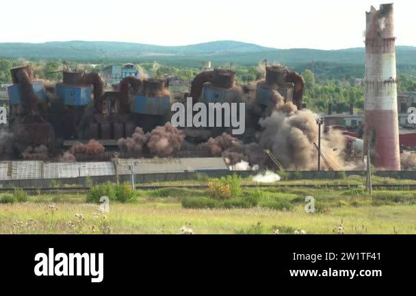 The collapse of an obsolete industrial chimney with an explosion ...