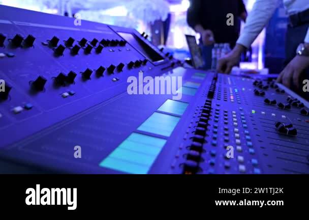 DJ control music console and colorful light in nightclub. DJ mixer ...