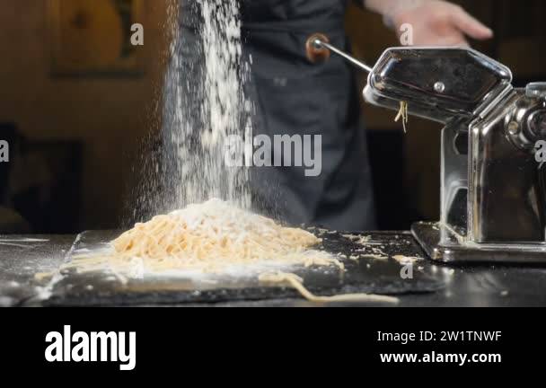 Traditional Italian homemade pasta. Flour falling from hand in slow ...
