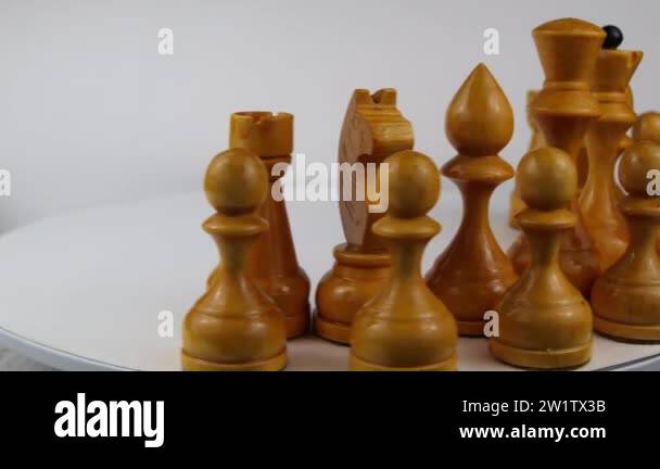 White chess pieces rotate on the round table from left to right. Slow ...