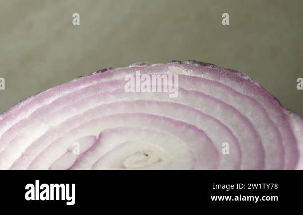 Sliced red onion rings rotating in 4K. Closeup top view of healthy food ...