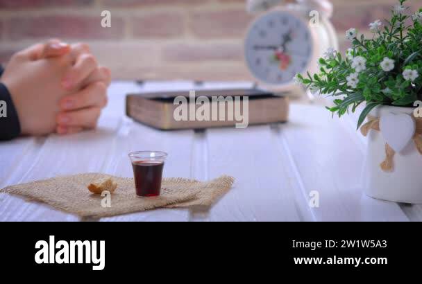 Young woman reading the Bible and taking communion - the wine and the ...