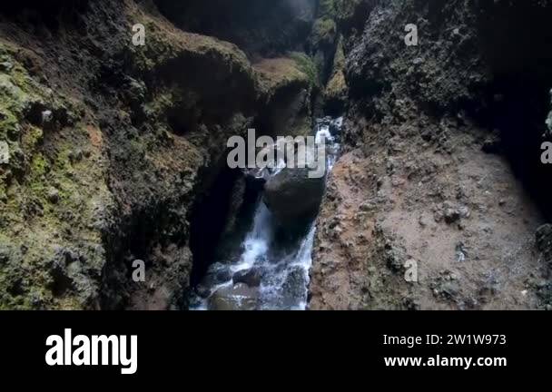 Stream of water inside Rauofeldsgja ravine gorge in Botnsfjall Mountain ...