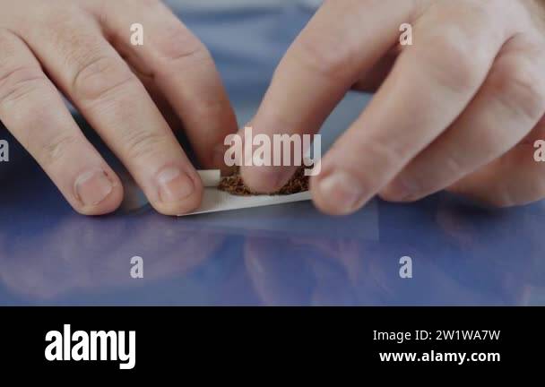 Man Hands Roll a Handmade Cigarette Using Cigarette Paper a Filter and ...
