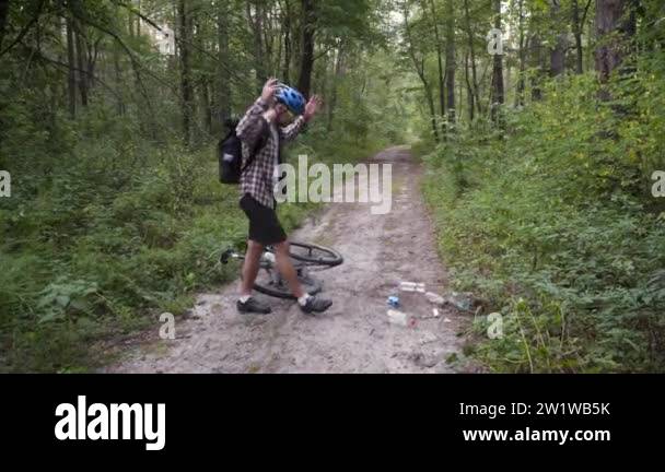 Man ride bicycle through forest, collecting trash. Trendy sports ...