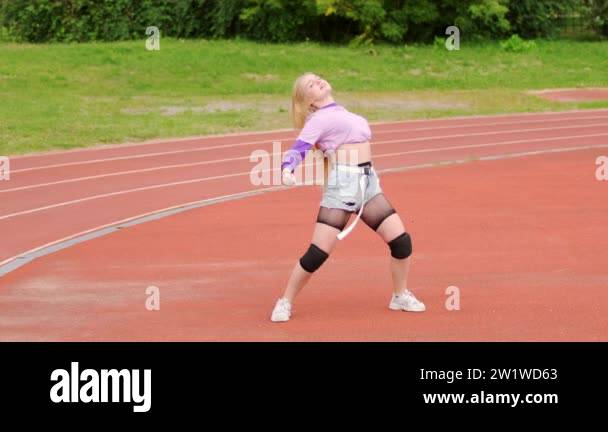 Young beautiful blonde woman dancing dancehall with twerking elements ...