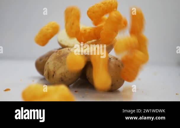 Crispy Potato Chips Golden Chips hang in the air in front of the lens ...