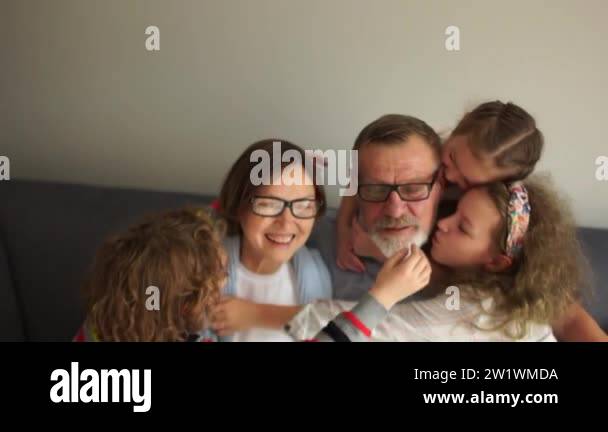 Happy grandfather and grandmother and their three grandchildren. Two ...