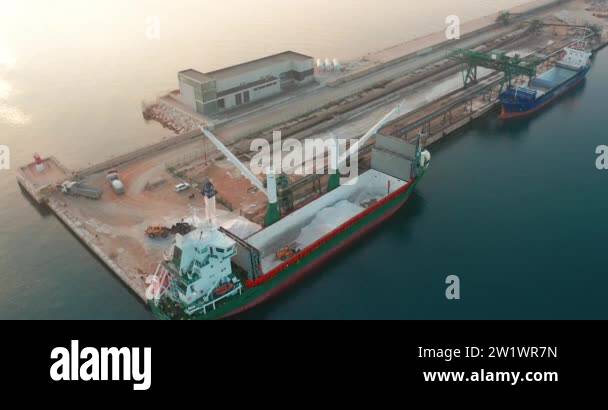 Aerial view. The ship arrived at the port. Unloading of cargo ship by ...