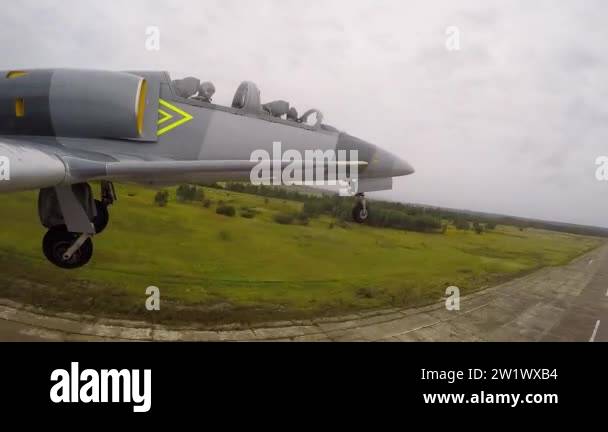 A gray blue combat fighter aircraft takes off from the ground, blast ...