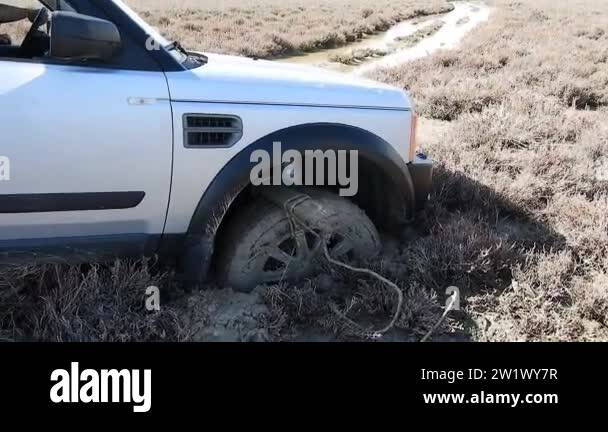 4x4 Car got stuck in the mud. The vehicle's brand, license plate and ...