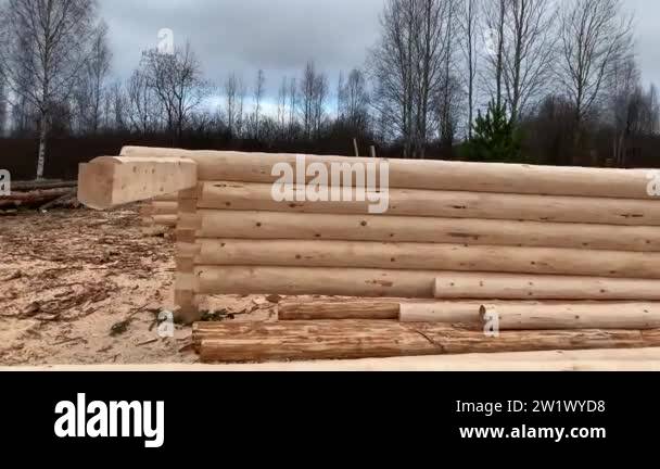 Drying and assembly of wooden log house at a construction base ...