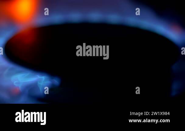 Methane firing up with blue flame on gas stove burner in total dark ...