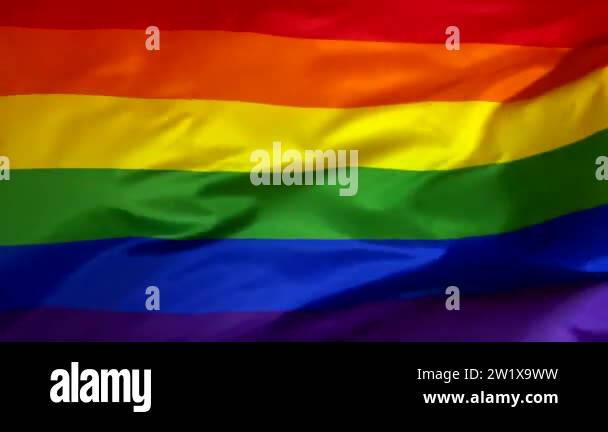 LGBT flag waving in the wind close-up. Colorful rainbow flag, LGBT ...
