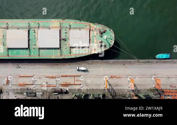 Top down view of cargo ship in dock port factory. Transportation view ...